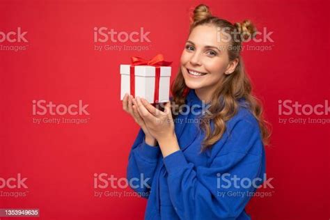 아름다운 행복한 젊은 금발의 여자 고립 된 화려한 배경 벽 입고 화려한 캐주얼 옷 선물 상자를 들고 카메라를 보고 경외감에 대한 스톡 사진 및 기타 이미지 Istock