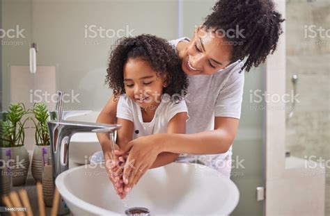 가족 엄마와 함께 손을 씻고 화장실에서 감염 또는 바이러스 보호를 위해 박테리아 또는 세균에 대한 헹굼 청소 및 좋은 위생 건강과 청결을 위해 여자와 함께 있는 소녀 아이