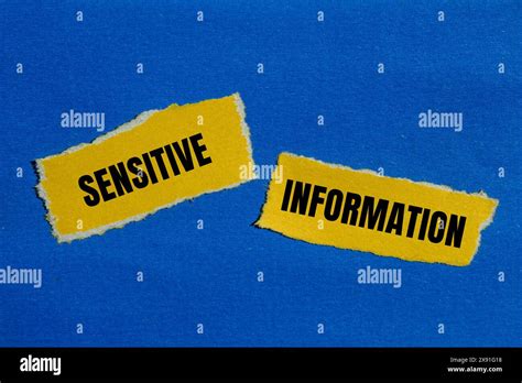 Sensitive Information Words Written On Ripped Yellow Paper Pieces With Blue Background
