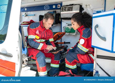 Paramedical Professionals Sitting In The Medical Emergency Vehicle