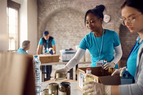 행복한 아프리카 계 미국인 자원 봉사자가 자선 센터의 기부 상자에 음식을 포장합니다 푸드뱅크에 대한 스톡 사진 및 기타 이미지 푸드뱅크 음식 기부 짐 싸기 Istock