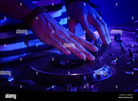 DJ Mixing Tracks On A Mixer In A Nightclub Stock Photo Alamy