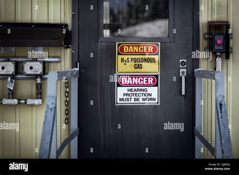 A Vertical View Of Signs With Text Hearing Protection Must Be Worn On