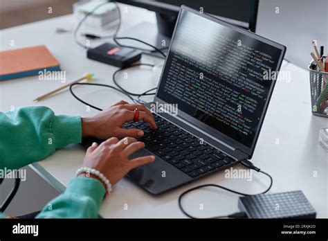 Close Up Of Woman Typing Codes On Laptop While Working At Her Workplace Close Up Of Woman Typing Codes On Laptop While Working At Her Workplace