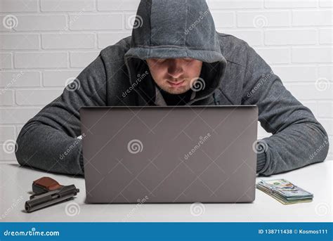 Hacker In A Hood Thinking About The Problem Of Hacking Or Malware Infection On The Background Of