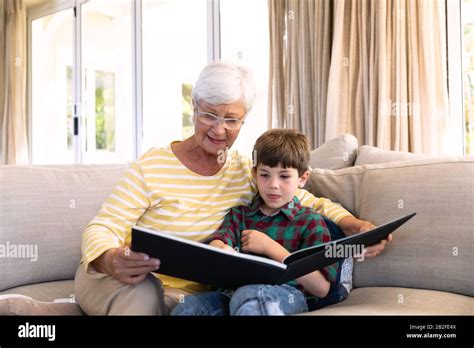 Front View Of A Caucasian Grandmother At Home Sitting On A Sofa In The