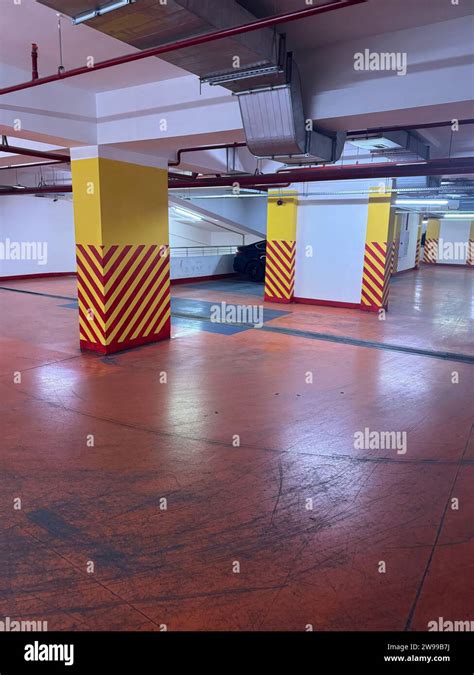 An Empty Parking Garage With Multiple Striped Concrete Columns Located