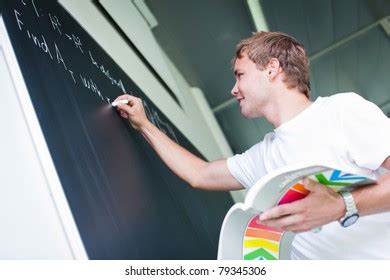 Student Solving A Science Problem On The Board Over Royalty Free