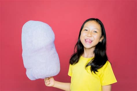 Premium Photo Girl Sticking Her Tongue Out While Holding A Candy