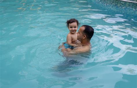 Father And Son Enjoying Swinging Pool Bath At Evening Stock Image Image Of Family Baby