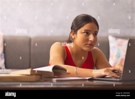 Portrait Of A Teenage Girl Doing Homework During Online Classes Stock Portrait Of A Teenage Girl Doing Homework During Online Classes Stock
