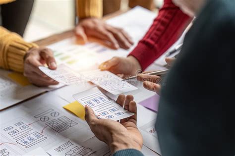 Group Of Ux Developer And Ui Designer Brainstorming About App Interface