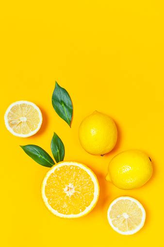 밝은 노란색 배경에 익은 육즙이 많은 레몬과 녹색 잎 레몬 과일 감귤류 최소 개념 비타민 C 창조적 인 여름 음식 최소한의 배경 플랫 레이 상단보기 복사 공간 가리기에 대한