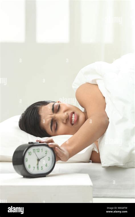 Woman Turning Alarm Off Stock Photo Alamy Woman Turning Alarm Off Stock Photo Alamy