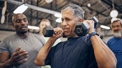 Premium Photo Fitness Old Man With Dumbbell And Help From Coach Or