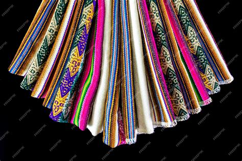 Premium Photo A Pile Of Colorful Andean Textiles Llicllas Photographed On A Black Background