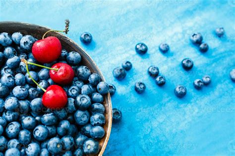 Blueberries On Colorful Blue Background Can Be Used For Blueberry