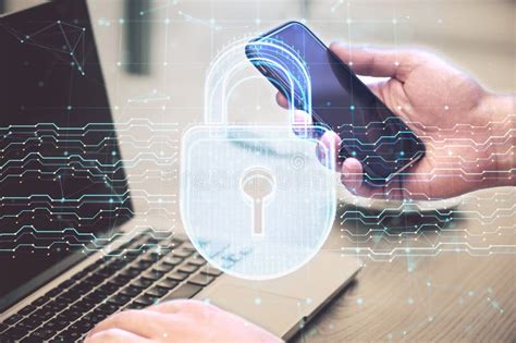 Close Up Of Businessman Hands Using Laptop Keyboard And Smartphone With Glowing Digital Padlock