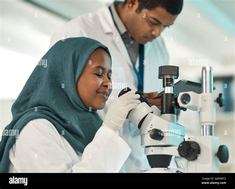 Conducting Controlled Tests A Young Scientist Using A Microscope While