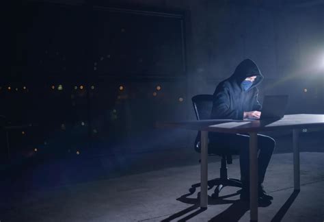 Hacker Using Laptop Computer While Working In Dark Office Stock Photo At Vecteezy