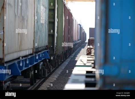 Unloading Containers At The Logistics Center Machines And Cranes Drag
