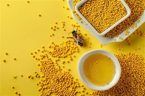 Premium Photo An Overhead View Of Bee Pollens And Honey In White Tray On Yellow Background