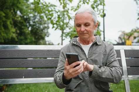 Old Man Browsing App On Smartphone Outdoor In Park Stock Photo Image Of Outdoor People