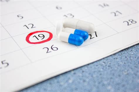 Premium Photo Monitoring The Intake Of Medications Medicines Pills And A Calendar Schedule Of