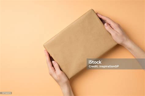 카피 스페이스와 고립 된 베이지 색 배경에 크래프트 종이 선물 상자를주는 소녀의 손의 1 인칭 최고 보기 사진 갈색에 대한 스톡 사진 및 기타 이미지 Istock