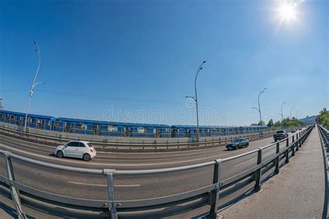 A Modern Highway With Multiple Lanes Running Parallel To A Railway