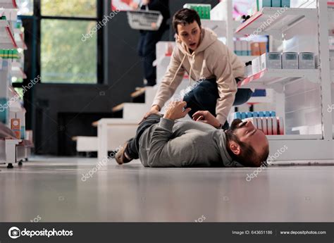 Woman Running Man Having Seizure Medical Retail Store Pharmacy Scared Stock Photo