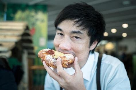 Portrait Of Man Eating Food At Restaurant Premium Photo