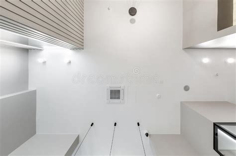 Suspended Ceiling With Halogen Spots Lamps And Drywall Construction In Empty Room In Apartment