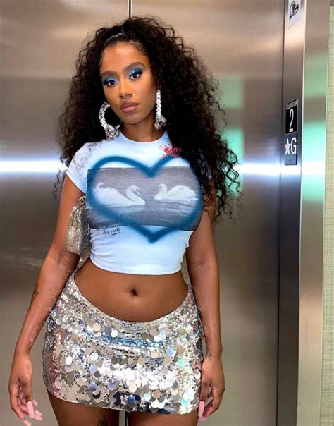 A Woman In A White Shirt And Silver Sequins Skirt Posing For The Camera