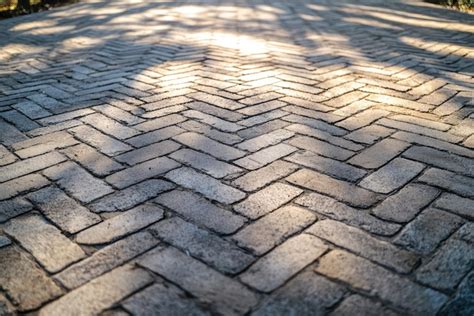 Sunlight Dappling On A Herringbone Brick Driveway A Rustic And Serene