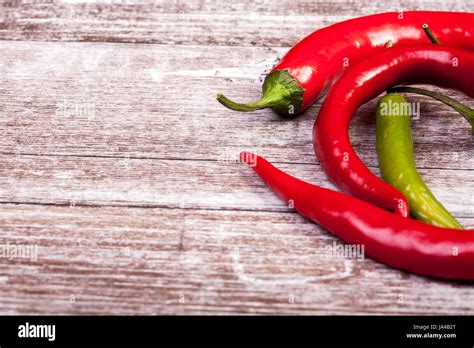 Green And Red Spicy Papper On Wooden Background In Studio Photo Fresh