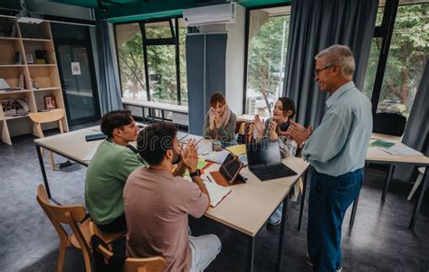 College Students Collaborating With Professor In Modern Classroom