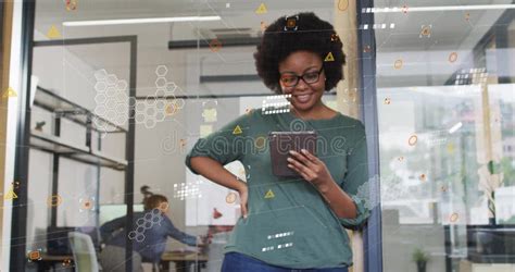 Image Of Digital Data Processing Over African American Businesswoman Using Tablet Stock Image
