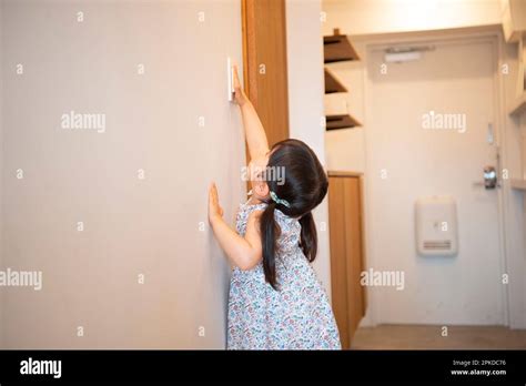 Girl Touching Light Switch Stock Photo Alamy