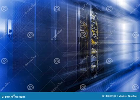 Server Racks Row In Big Data Center With Depth Of Field In Cool Blue Tone And Motion Effect