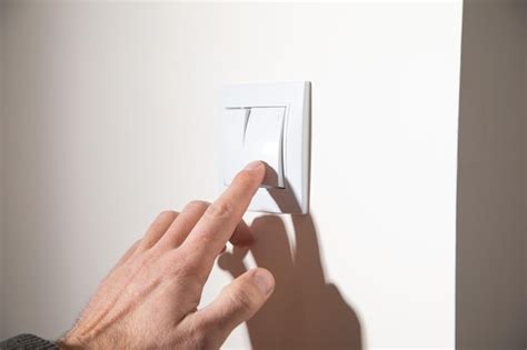 Premium Photo Male Hand Turning Off Or On Light Switch