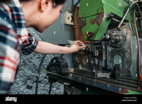 Seriously Milling Machine Female Staff Put Finished Parts Into Industrial Machine Prepare