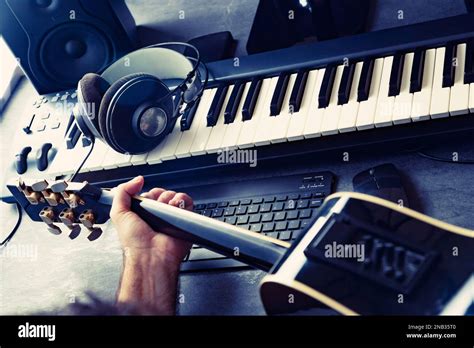 Keyboard Or Synthesizer And Guitarist With Headphones And Sound Card Computer Recording And