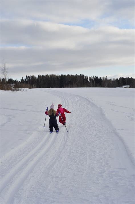 Two Young Girls Skiing And Walking In Winter Wonderland Flat Skiing Is