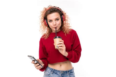 Premium Photo Caucasian Girl With Curly Fair Hair Drinks Coffe