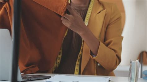 Caucasian Female Fashion Designer Works In Studio By Idea Drawing Sketches With Digital Tablet