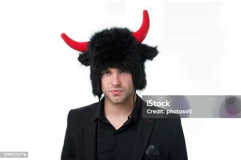 그는 완고한 성격을 가지고 있습니다 남자는 엄격한 얼굴은 뿔 악마 또는 황소의 모자를 착용 가이 블랙 클래식 슈트 강한 캐릭터 또는 성질 사업가는 자신감 고집과 행동에 강한