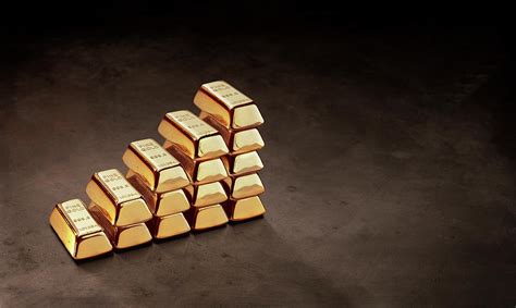 stepped stack of gold on dark surface by anthony bradshaw