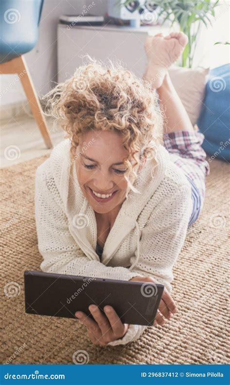 Woman Laying At Home On The Carpet Floor And Use Laptop Device With