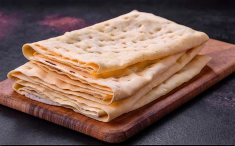 Premium Photo Sheets Of Traditional Thin Lavash Bread On A Wooden Table
